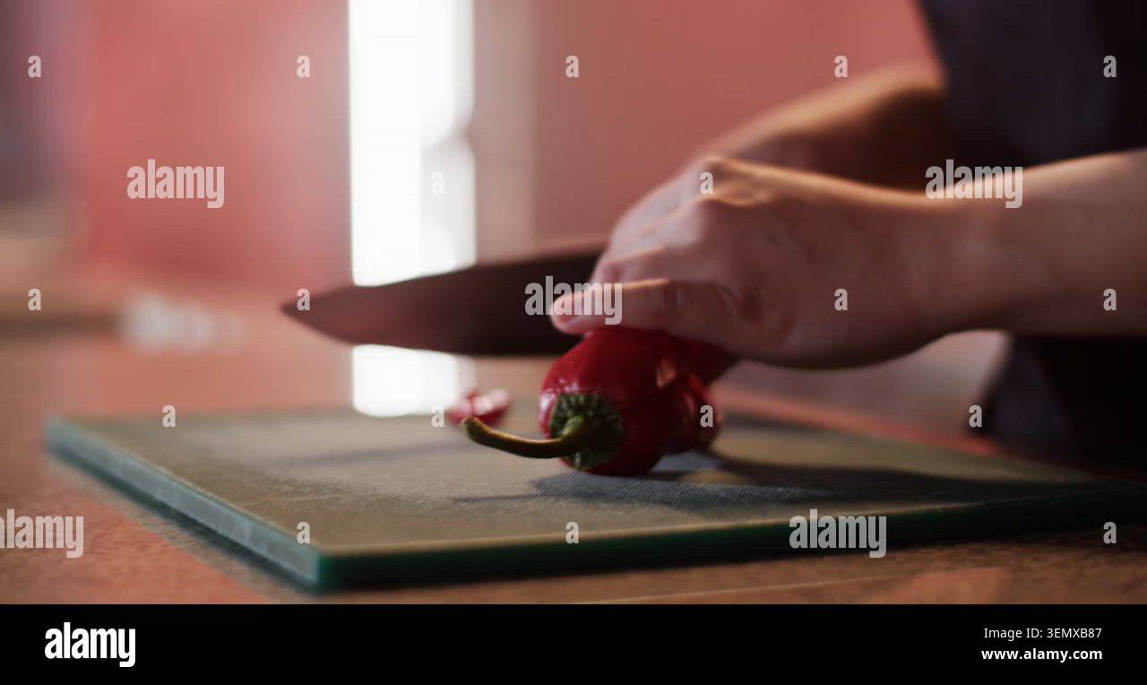 Woman chef cuts bell pepper in restaurant Stock Video Footage - Alamy