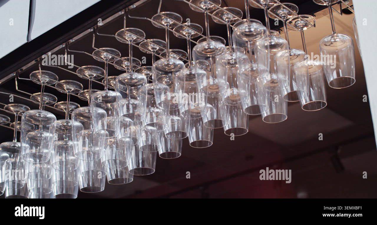 Glasses hang on rack over bar counter Stock Video Footage - Alamy