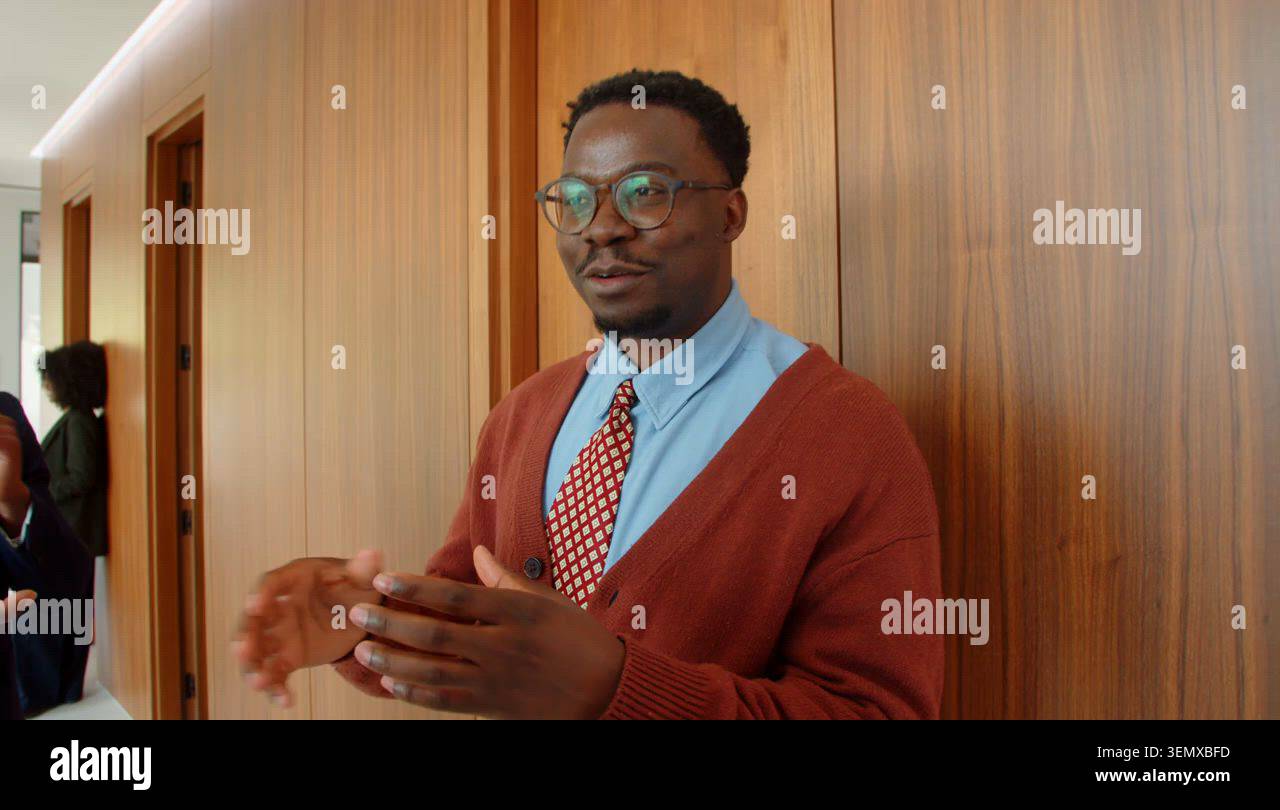 Stylish man conversing with his colleagues in a hallway Stock Video ...