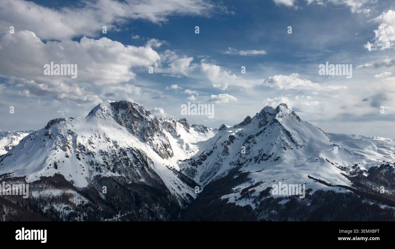 Snowy mountains and blue sky with clouds, drone time-lapse Stock Video ...