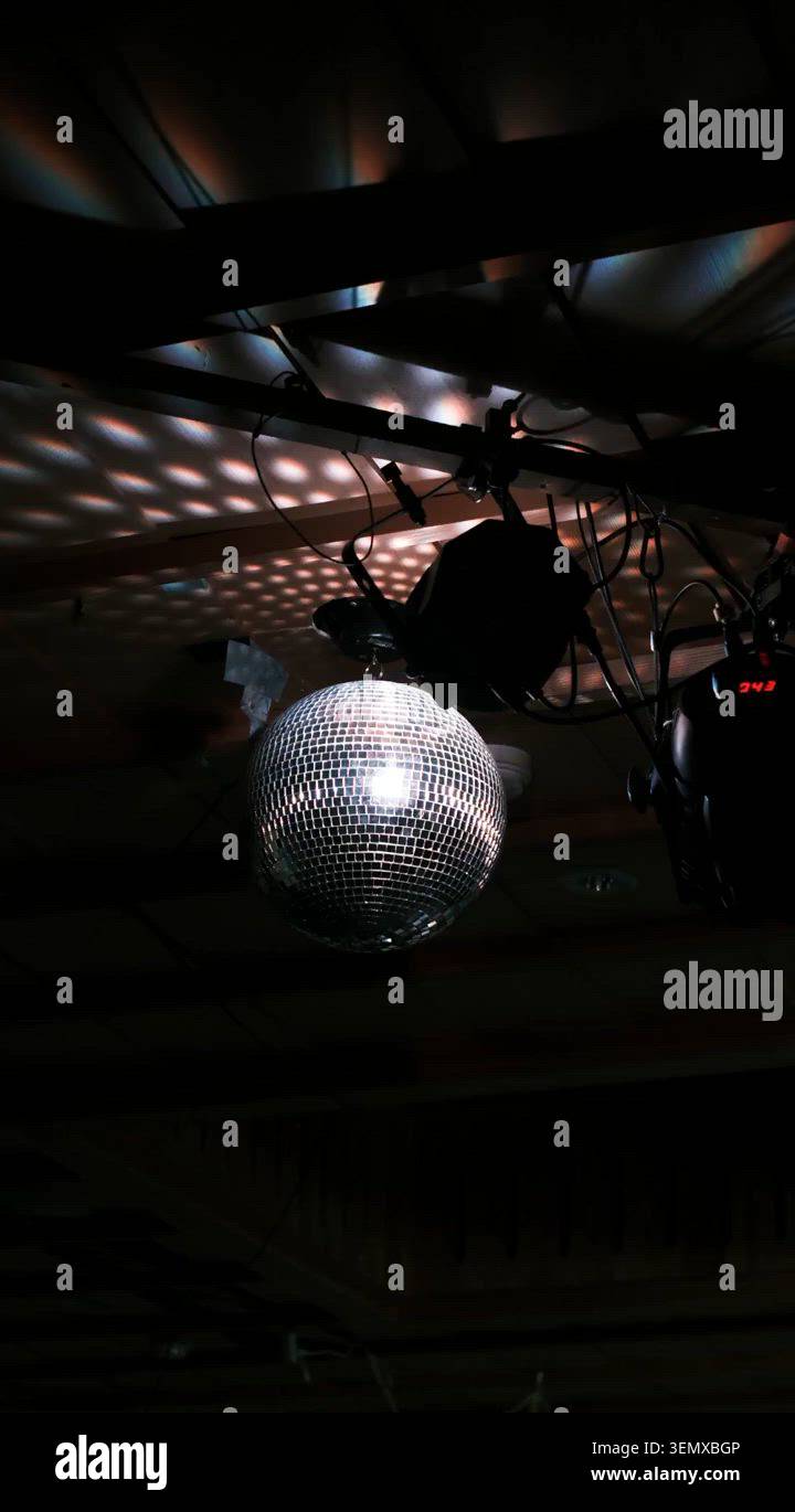 Spinning Mirror Disco Ball Reflecting Light in a Dark Club Environment ...