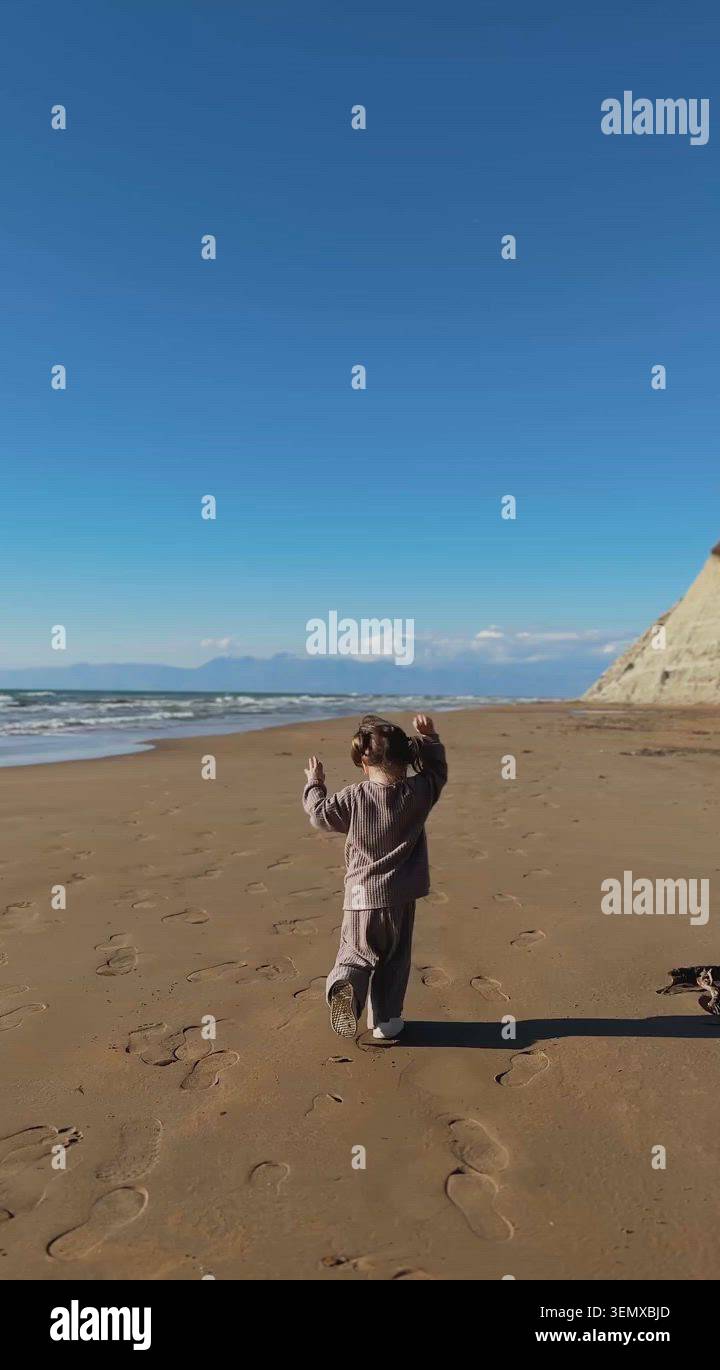 little toddler walking on the beach Stock Video Footage - Alamy