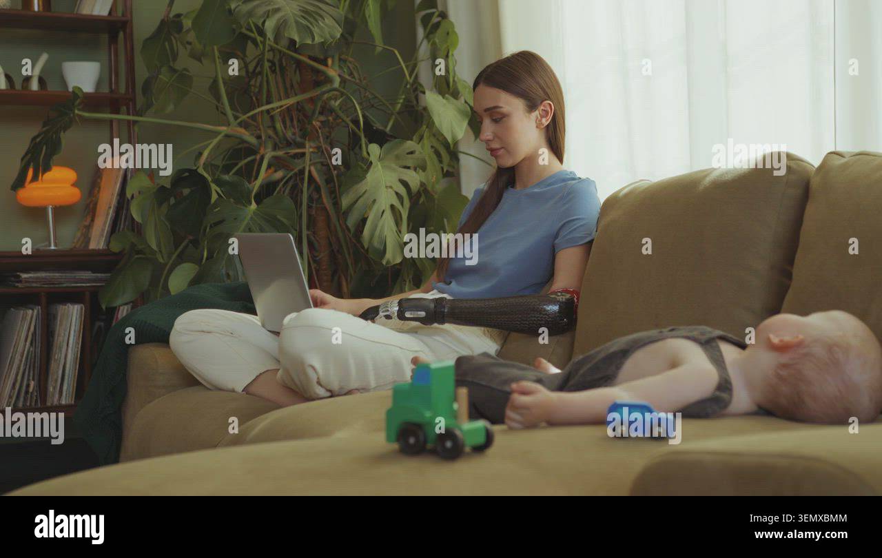 Mother Typing Beside Sleeping Son Stock Video Footage - Alamy