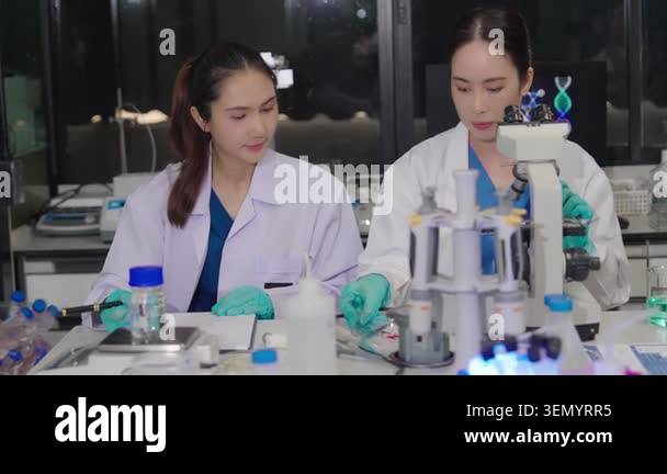 Young researchers are analyzing samples and taking notes in the science ...