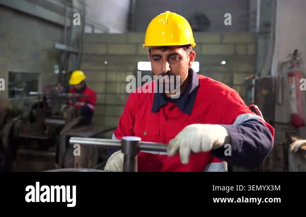 A professional team of two mechanical engineers in uniform and safety ...