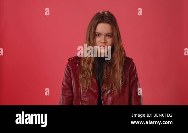 A woman in a red jacket displays a strong, expressive emotion, set ...
