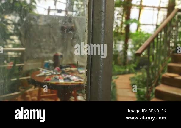 Painting easel with art supplies and protective mask inside a lush ...
