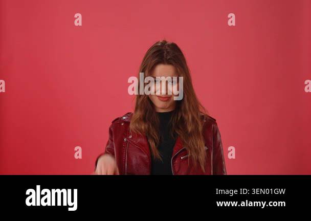 A person wearing a red jacket makes a humorous facial expression using ...