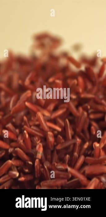 Red rice flies up and falls down. Filmed on a high-speed camera at 1000 ...