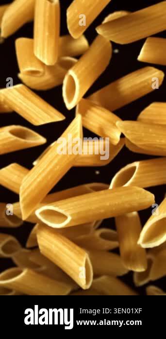 Super slow motion flying dry penne pasta . Filmed on a high-speed ...