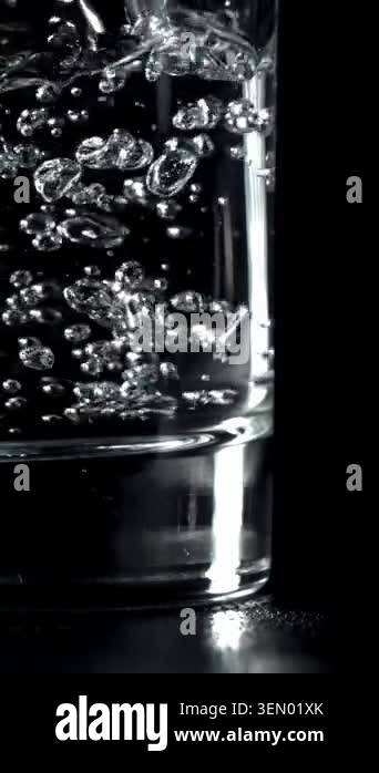 Vodka is poured into a glass. Filmed on a high-speed camera at 1000 fps ...