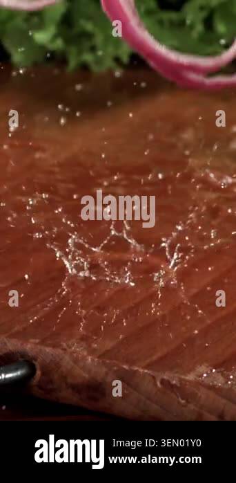 The chopped onion falls onto the cutting board. Filmed on a high-speed ...