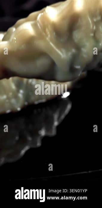 Traditional gyoze dumplings are falling in soy sauce. Filmed on a high ...