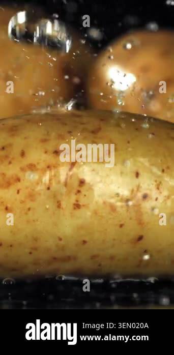 Water droplets fall on the potatoes. Filmed on a high-speed camera at ...