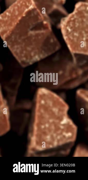 Super slow motion pieces of dark milk chocolate. Filmed on a high-speed ...