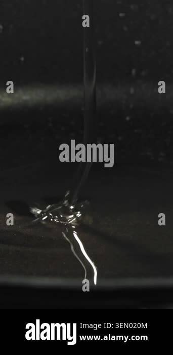 The oil is poured into a frying pan. Filmed on a high-speed camera at ...