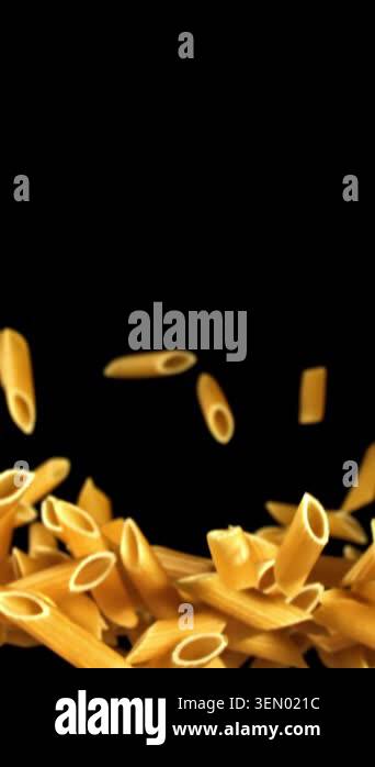 Super slow motion flying dry penne pasta . Filmed on a high-speed ...