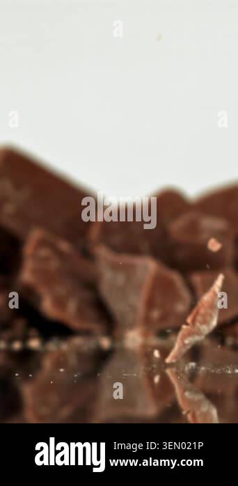 Super slow motion pieces of dark milk chocolate. Filmed on a high-speed ...