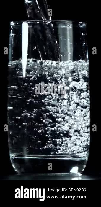 Water is poured into a glass. Filmed on a high-speed camera at 1000 fps ...
