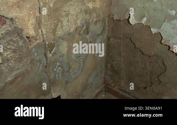 Close up of an old neglected interior wall corner showing extensive ...