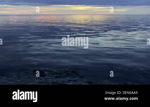 Calm Ocean at Dusk with Subtle Sunset Hues Stock Video Footage - Alamy