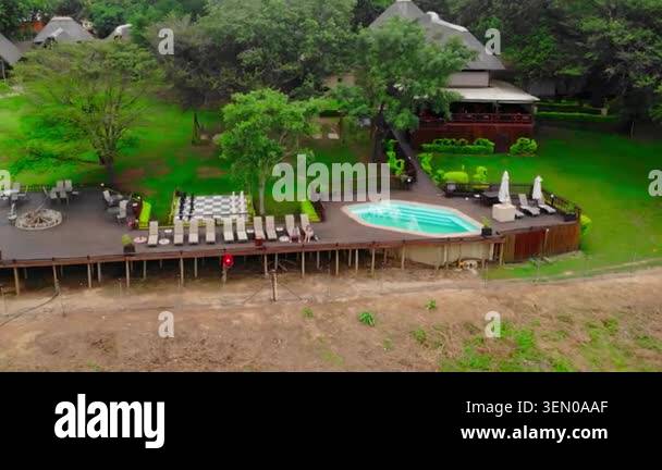 Aerial View Safari Lodge Pool Deck With Thatched Bungalows Surrounded ...