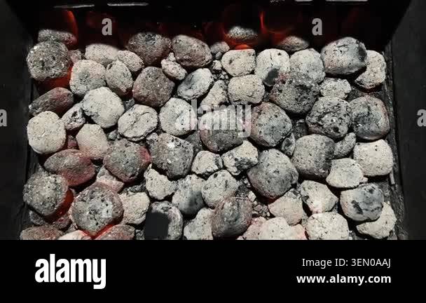 Hot charcoal embers covered with white ash in a grill or fire pit ...