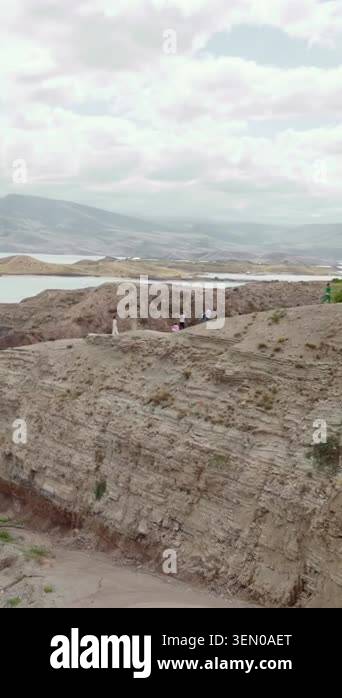 Cliff Overlooking Calm Lake Under Cloudy Sky, Distant Hills, Soft Light ...