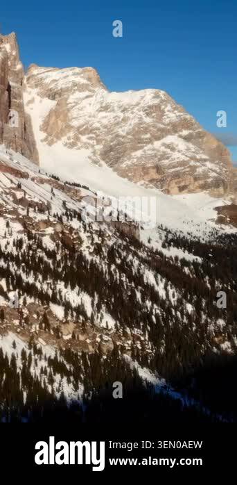 Sunlit Snow Covered Mountain Cliffs Aerial Drone View Featuring Rugged ...