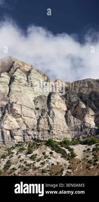 Rocky Mountain Peak Under Blue Sky, Framed By Drifting Clouds And ...