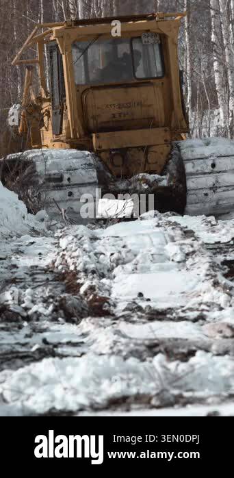 Yellow Bulldozer Clearing Snowy Forest Road, Tracked Tractor Pushes ...