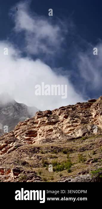 Rocky Mountain Peak Under Blue Sky, Framed By Drifting Clouds And ...