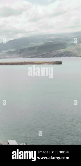 Cliff Overlooking Calm Lake Under Cloudy Sky, Distant Hills, Soft Light ...