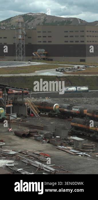 Freight Train Passes Industrial Processing Plant Under Overcast Sky ...