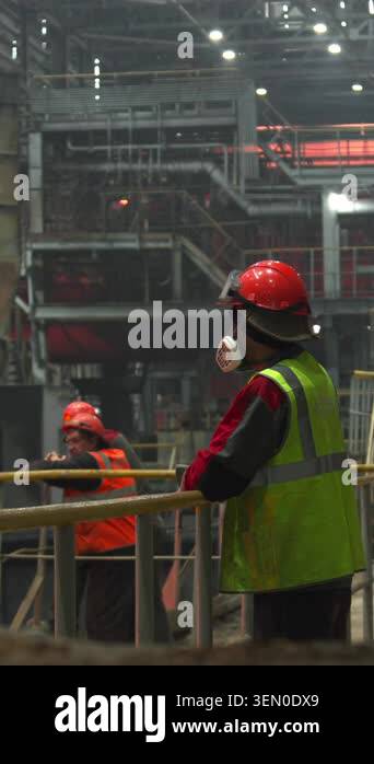 Supervisor In Reflective Vest Surveys Plant, Calm Inspection Of Highbay ...