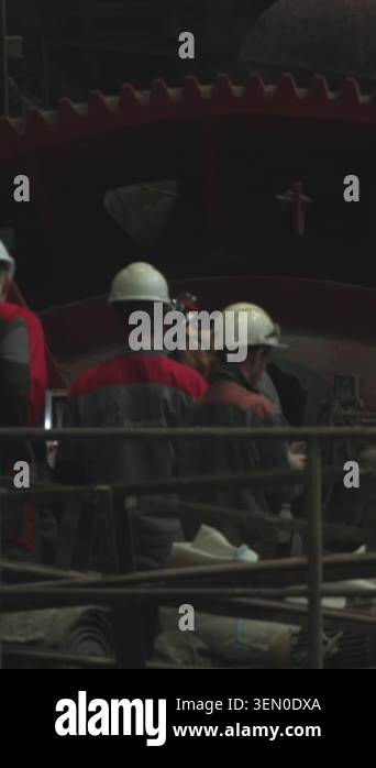 Crew Of Workers Align Under Giant Gear, Collaborative Safety Briefing ...
