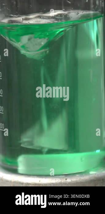 Beaker With Green Vortex Stirring Liquid In Closeup On Magnetic Stir ...