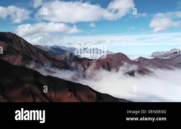 Wide scenic mountain landscape with dark rocky ridges, distant layered ...