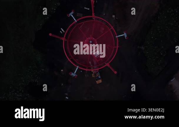 Aerial overhead view of a centered red circular industrial structure ...