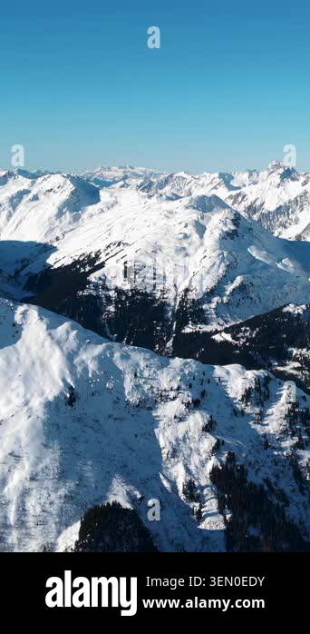 Sunlit Alpine Peaks Under Clear Blue Sky, Panoramic Aerial View Of ...
