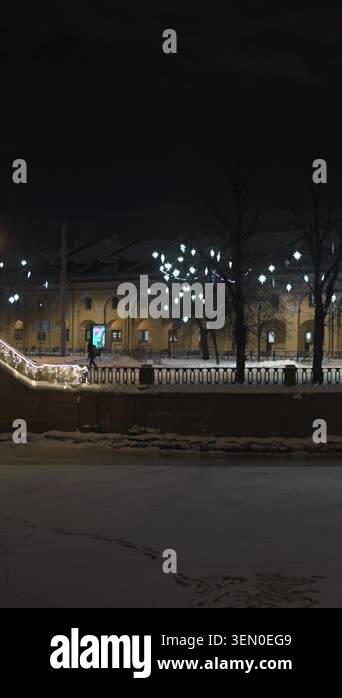Snowy Park Path With Lit Trees And Visible Footprints, Bridge And ...