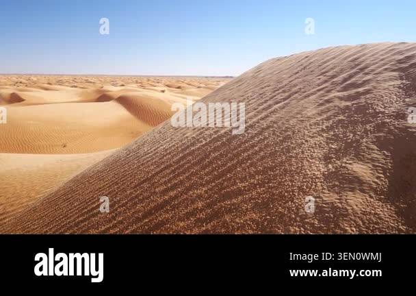 Wind shaped sand dunes at Ksar Ghilane, Tunisia, stretching across the ...