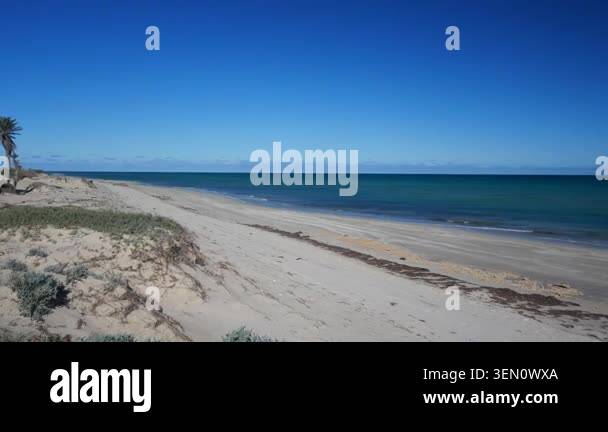 Panorama: Peaceful sandy beach on Djerba island, Tunisia, with shallow ...