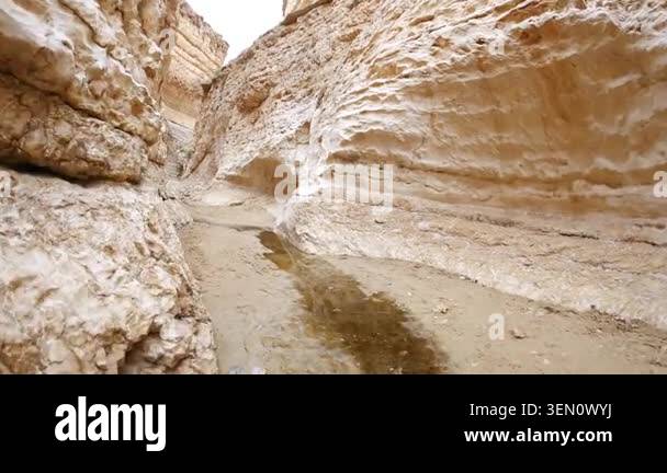 Narrow rock corridor in Mides Canyon, southern Tunisia, with layered ...