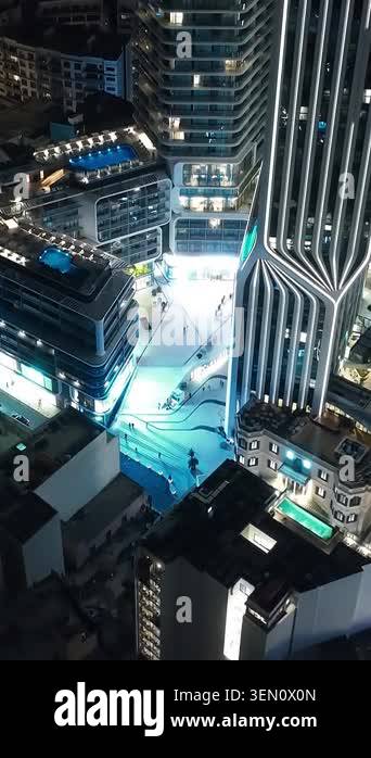 Aerial of night view of Paceville, St. Julians city with modern towers ...