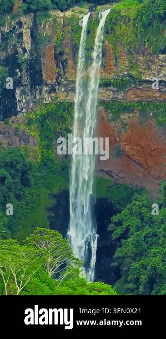 Aerial view of Chamarel Waterfall, plunging from verdant cliff into ...