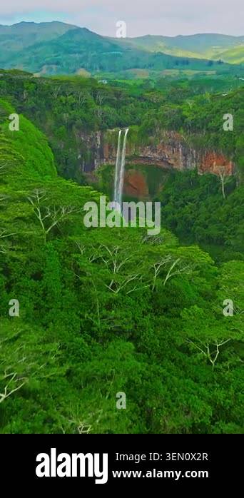 Aerial view of Chamarel Waterfall, plunging from verdant cliff into ...