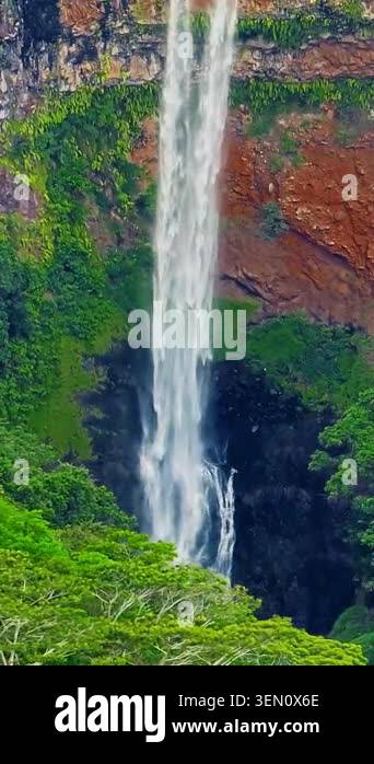 Aerial view of Chamarel Waterfall, plunging from verdant cliff into ...