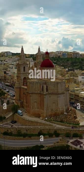 Aerial view of the Mellieha Church with red dome and the sea in the ...