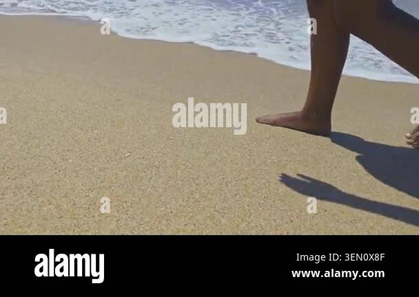 A super slow-motion video of a teenage girl's feet walking along a ...